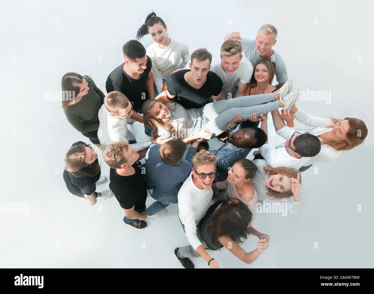 happy team of young people rocking their leader Stock Photo - Alamy