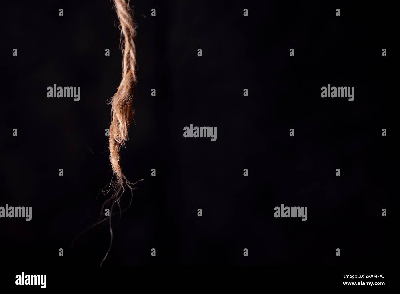 Broken rope on black background Stock Photo - Alamy