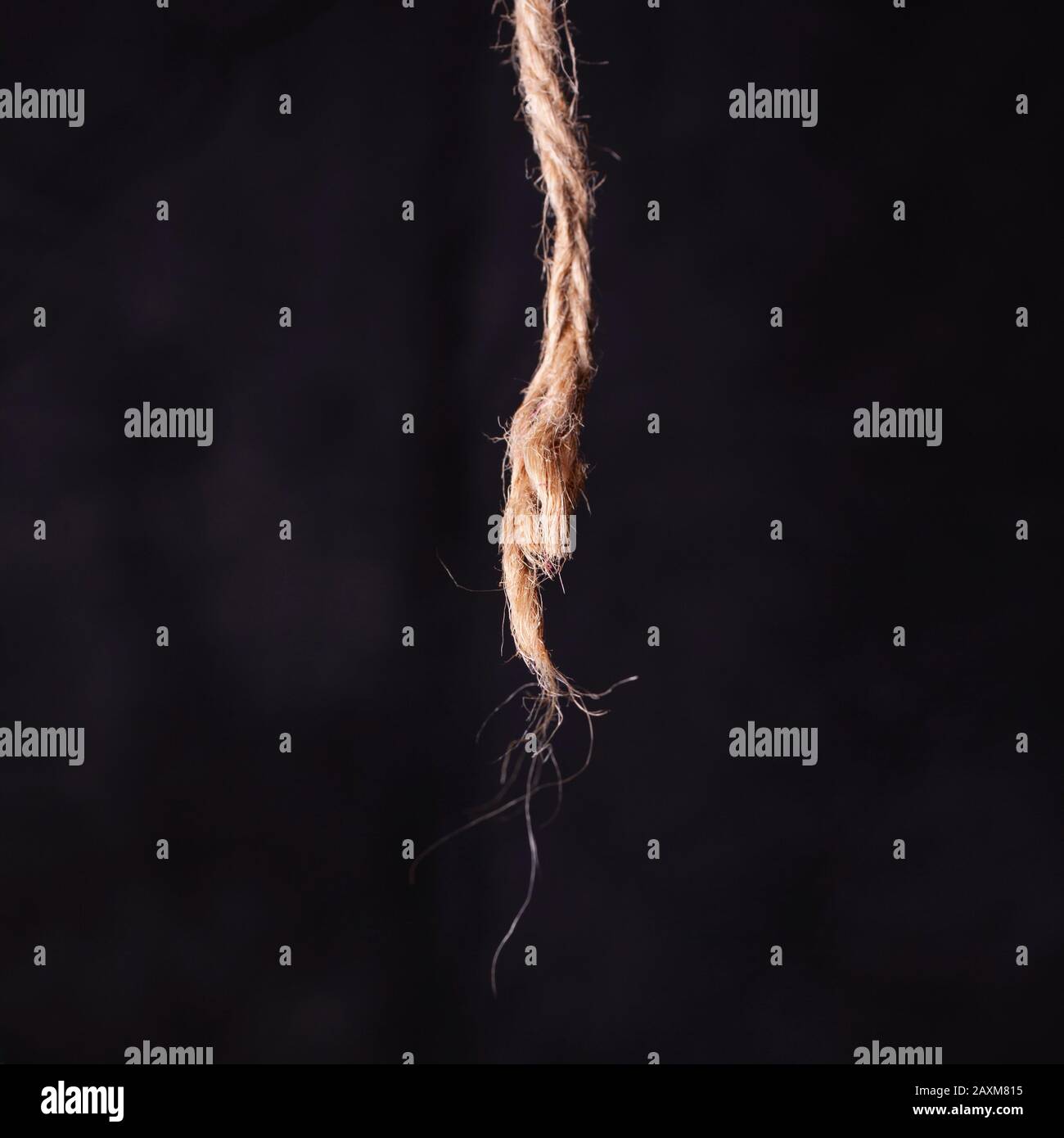 broken rope on black background Stock Photo - Alamy