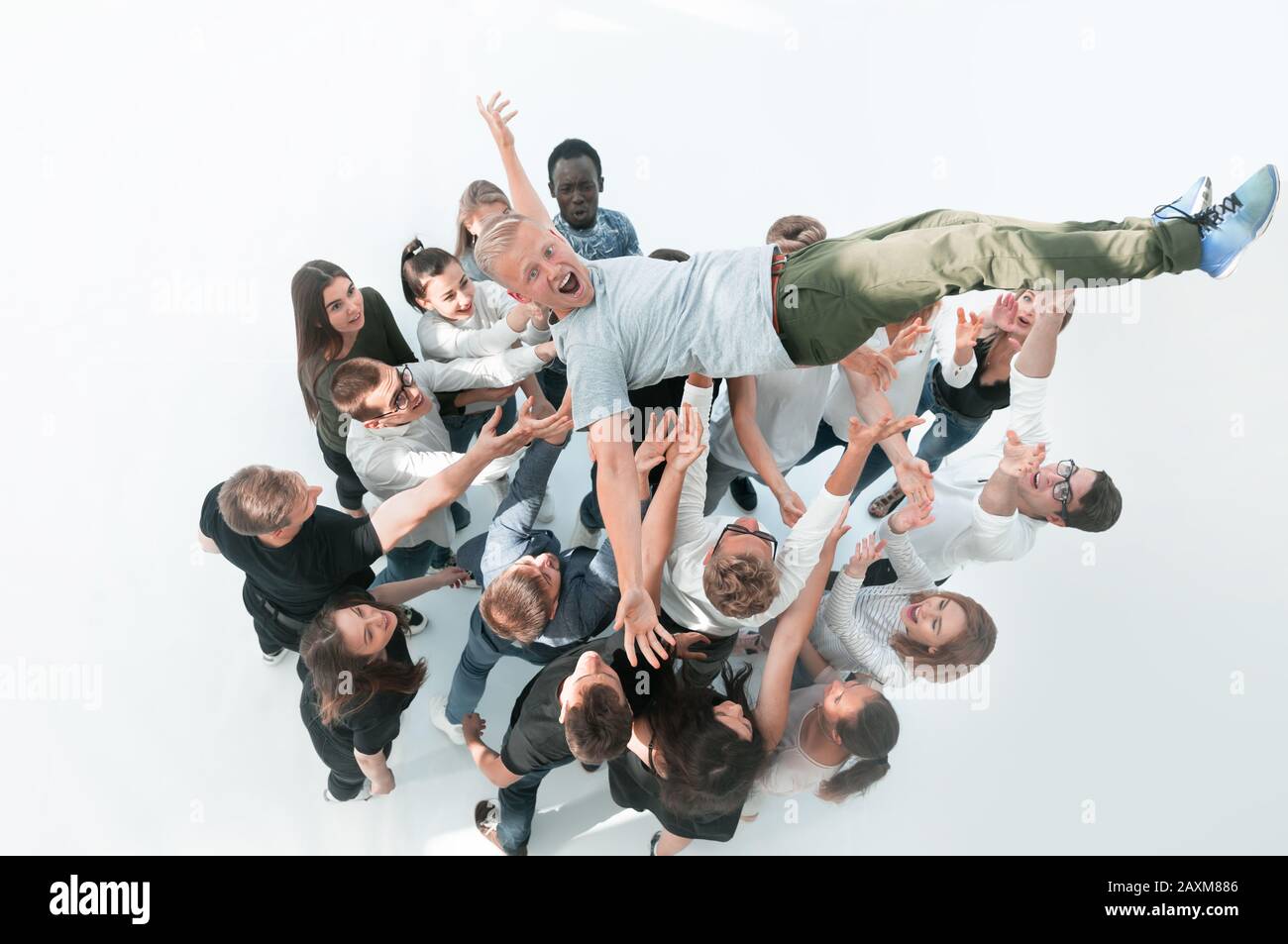top view.happy team of young people tossing up their leader Stock Photo ...