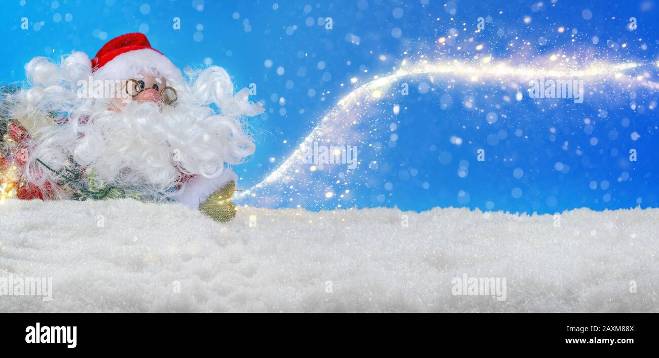 Santa Claus in the snow with stardust Stock Photo - Alamy