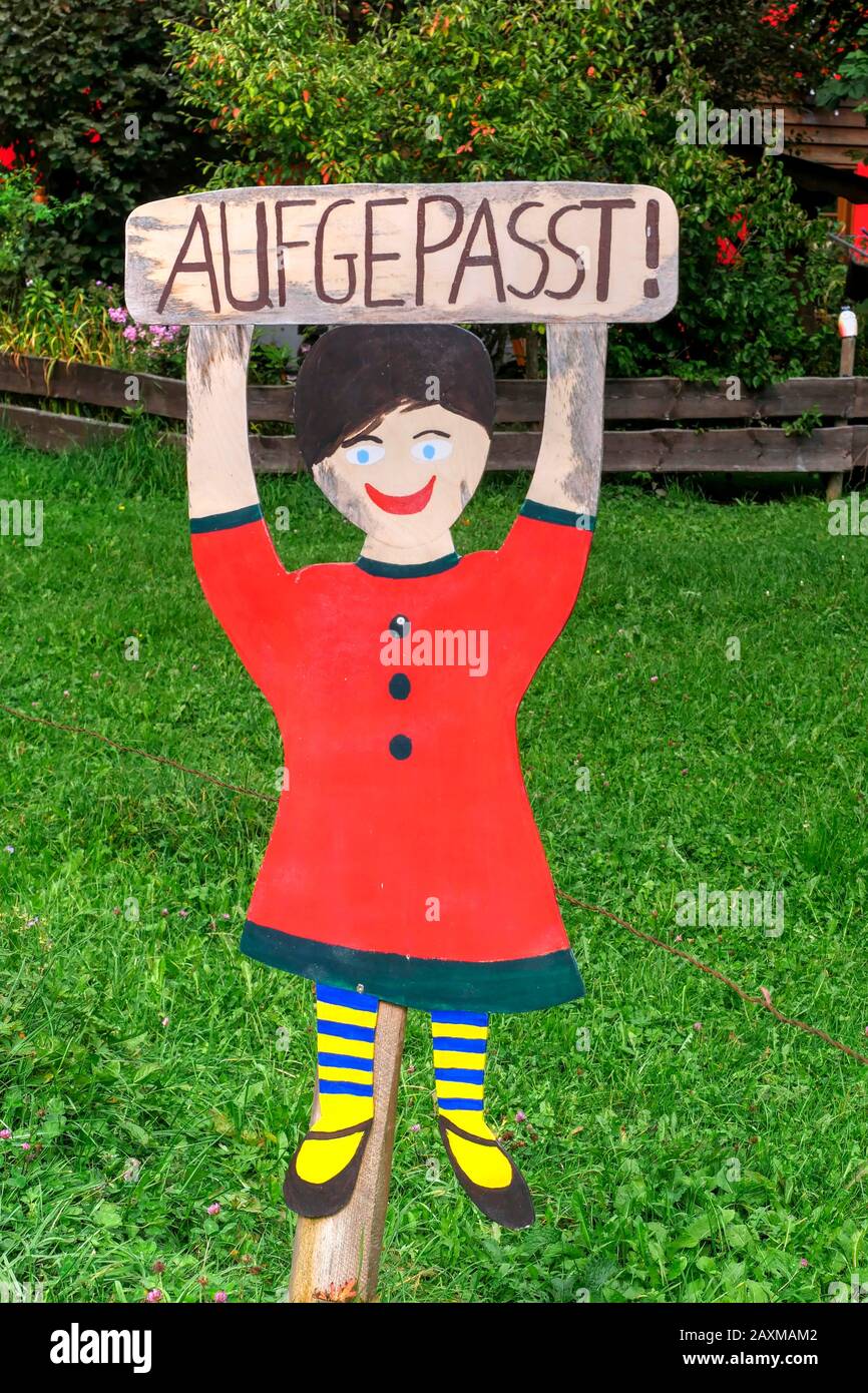 Wooden sign 'Watch out children' in the garden Stock Photo - Alamy