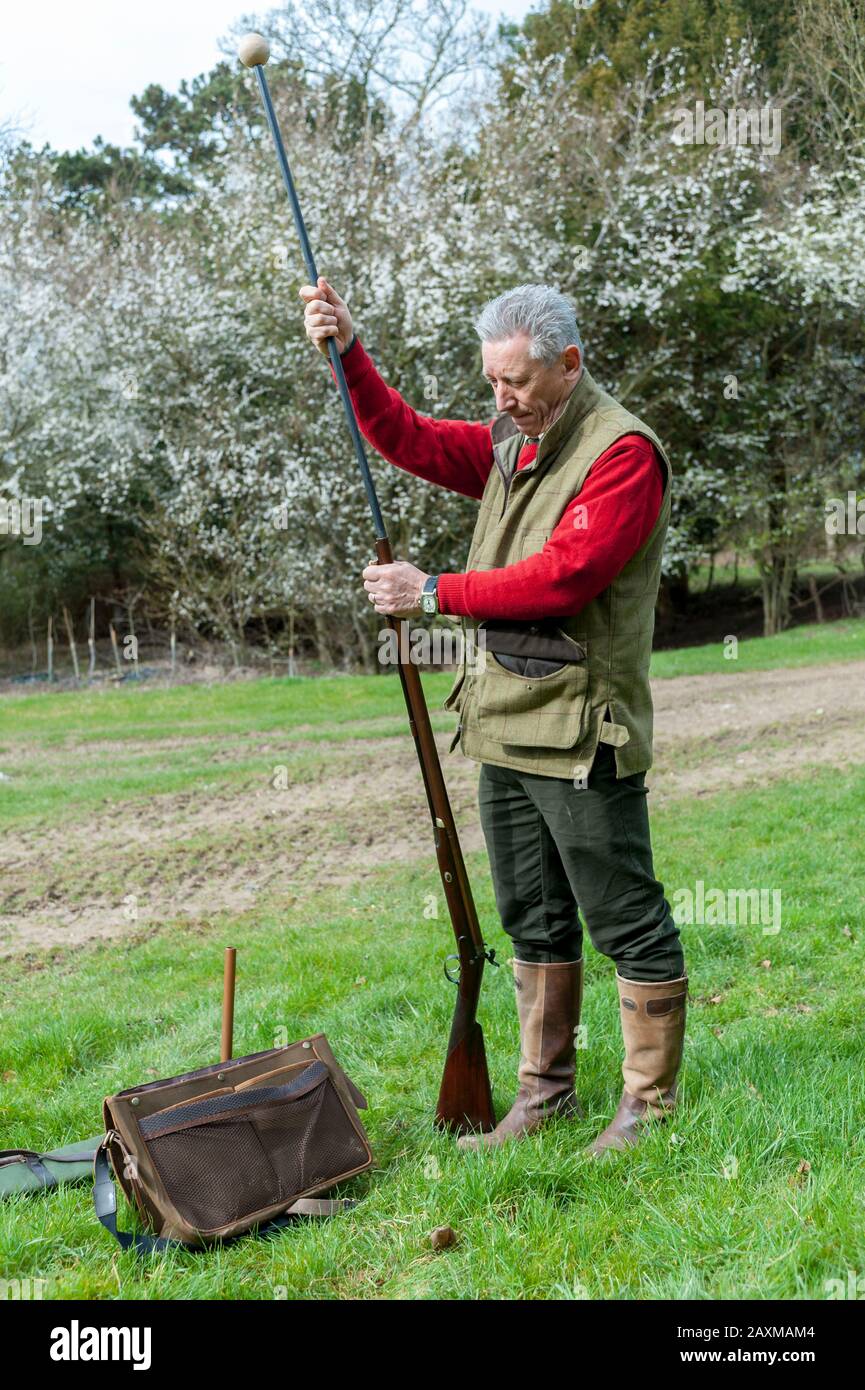 A man loading an antique black powder muzzle loading shotgun on a game ...