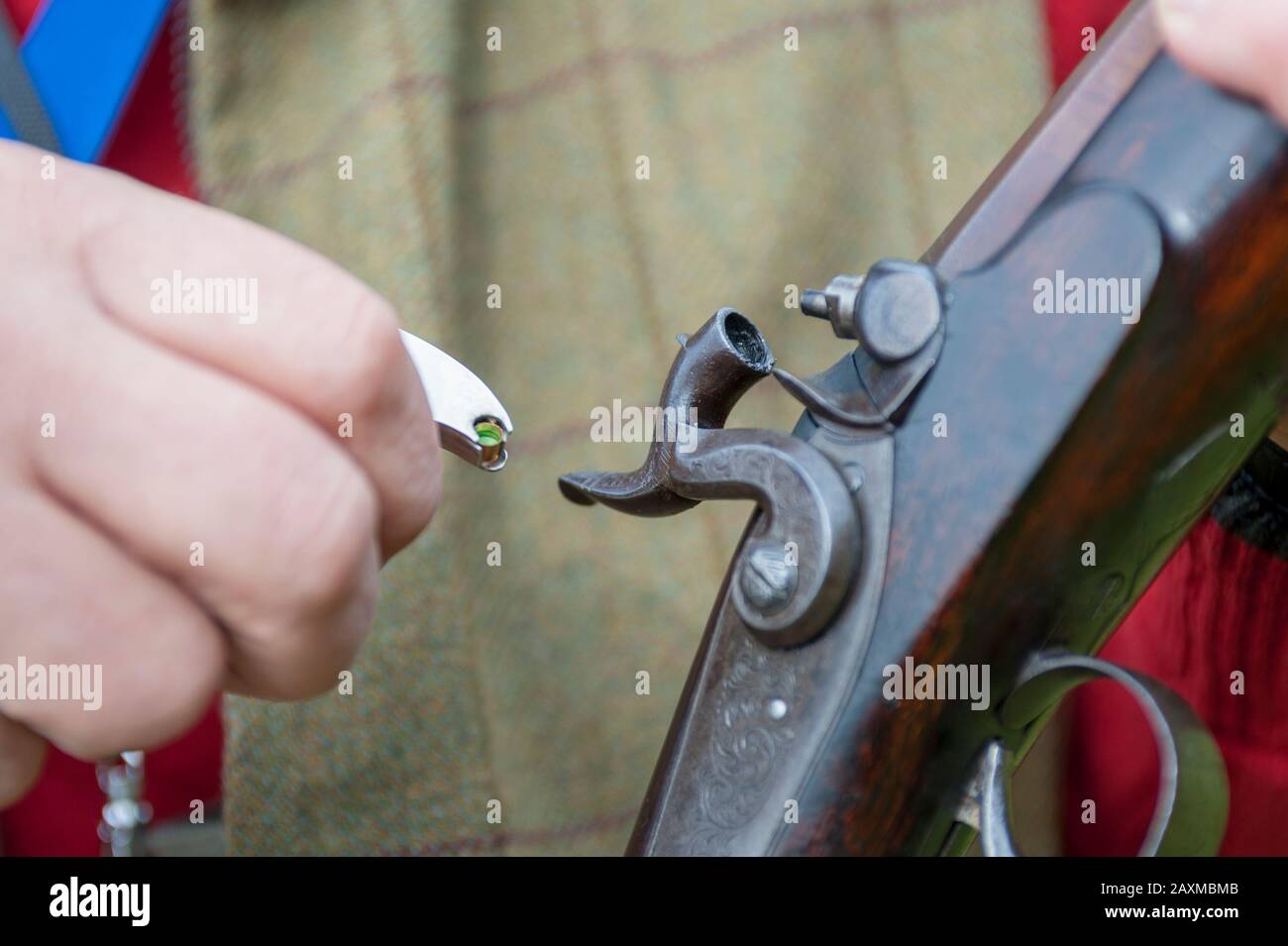 A man loading an antique black powder muzzleloading shotgun on a game ...