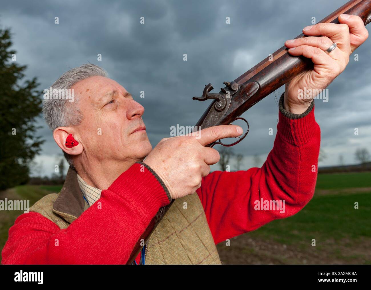 A man firing an antique black powder muzzleloading shotgun on a game ...