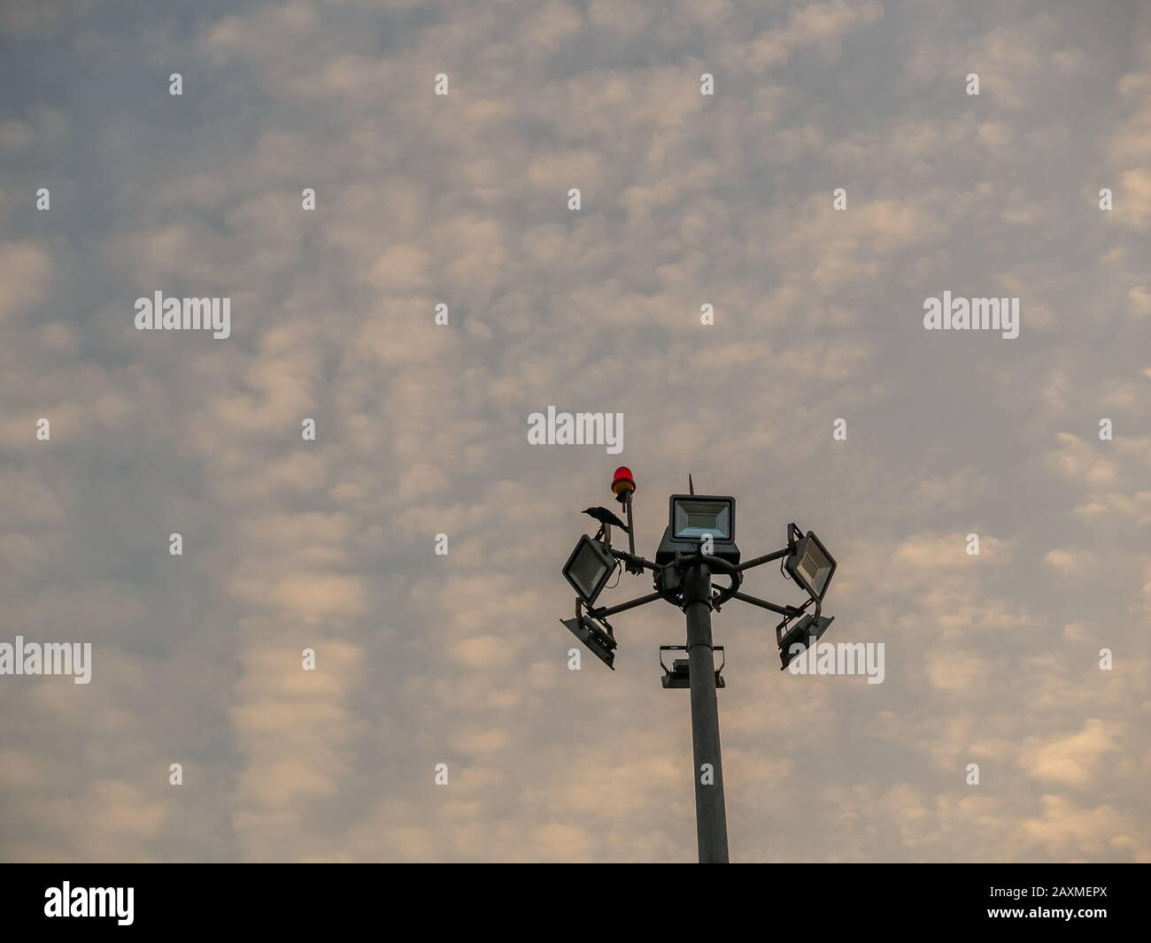 Light pole tower with cloudy sky Stock Photo - Alamy