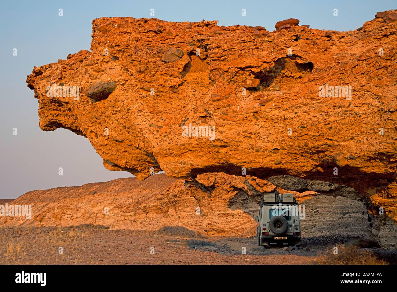 washed-out, projecting terraces and cave at the bluff with coloured ...