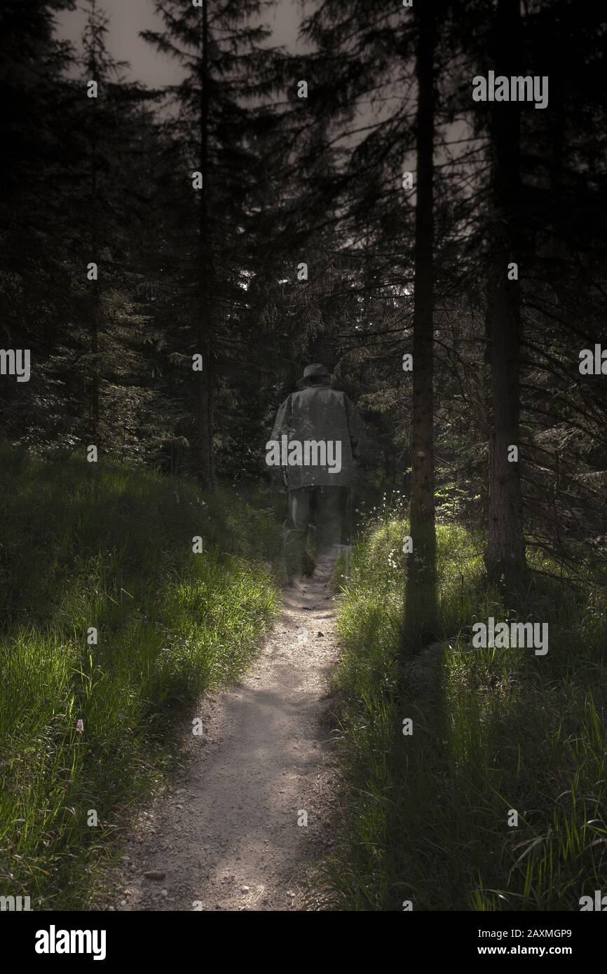 old man as an eerie apparition in gloomy forest Stock Photo - Alamy
