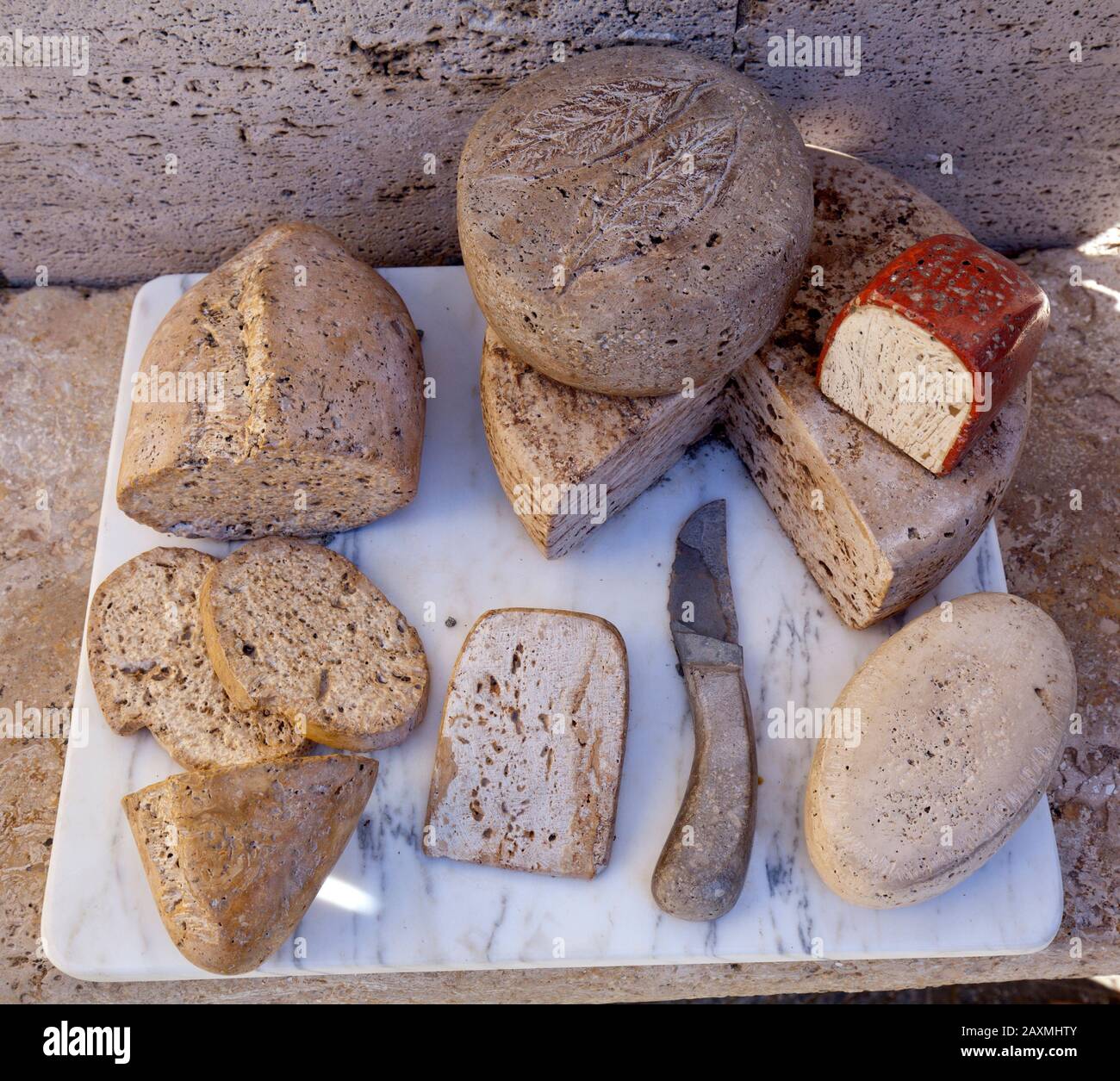 Cheese types made from stone with bread and knife on marble slab Stock ...