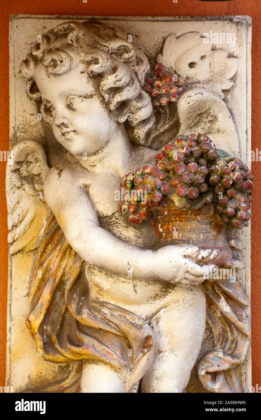 Angel carrying basket filled with grapes Stock Photo - Alamy