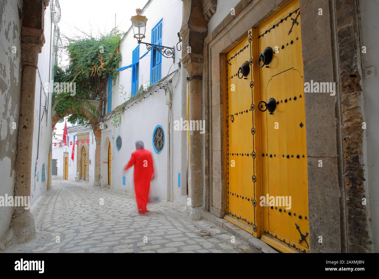 Typical cobbled and narrow street (Dar el Jeld street) with colorful ...