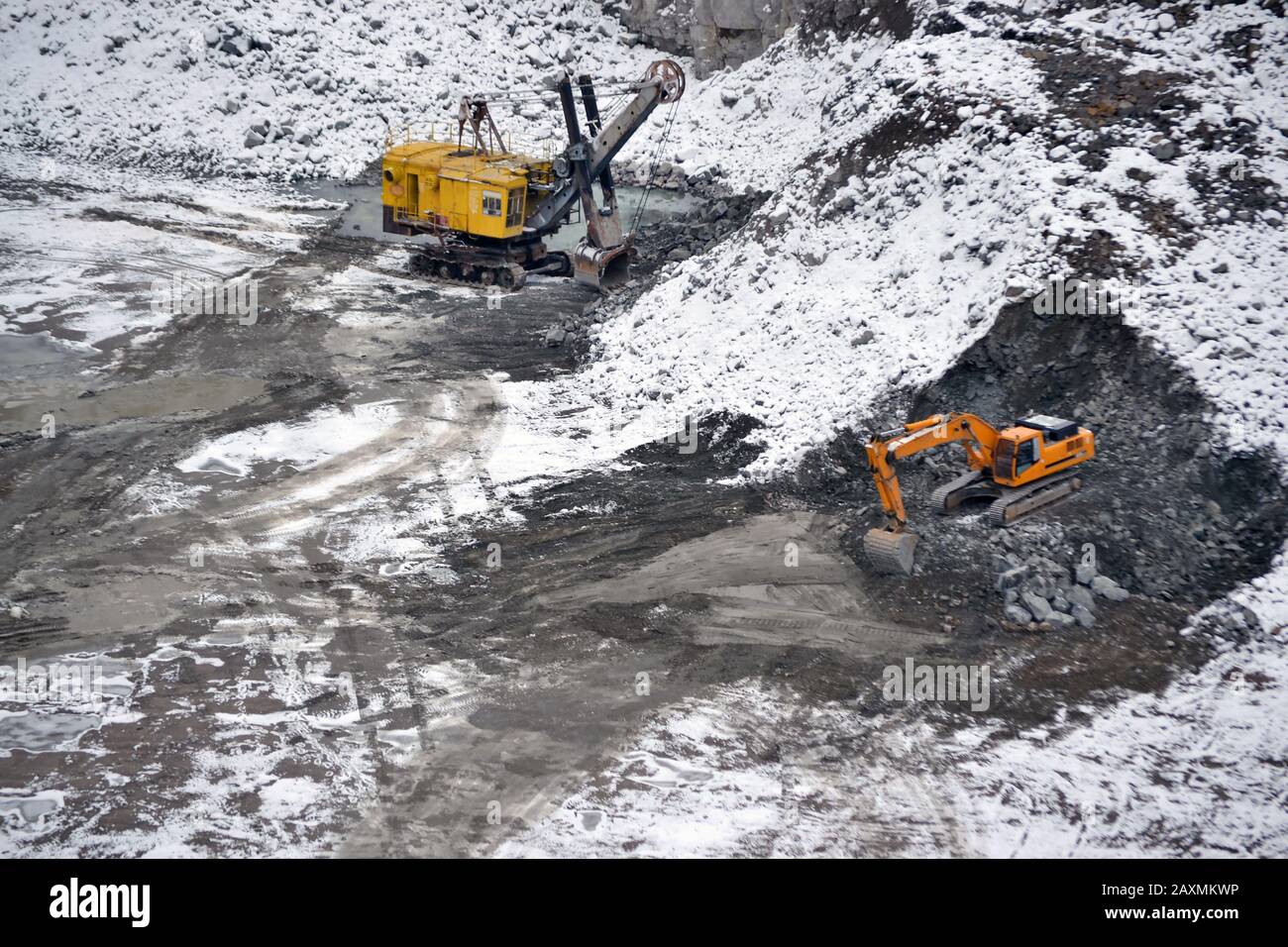 big huge yellow excavator and Machine for breaking stones in a granite ...