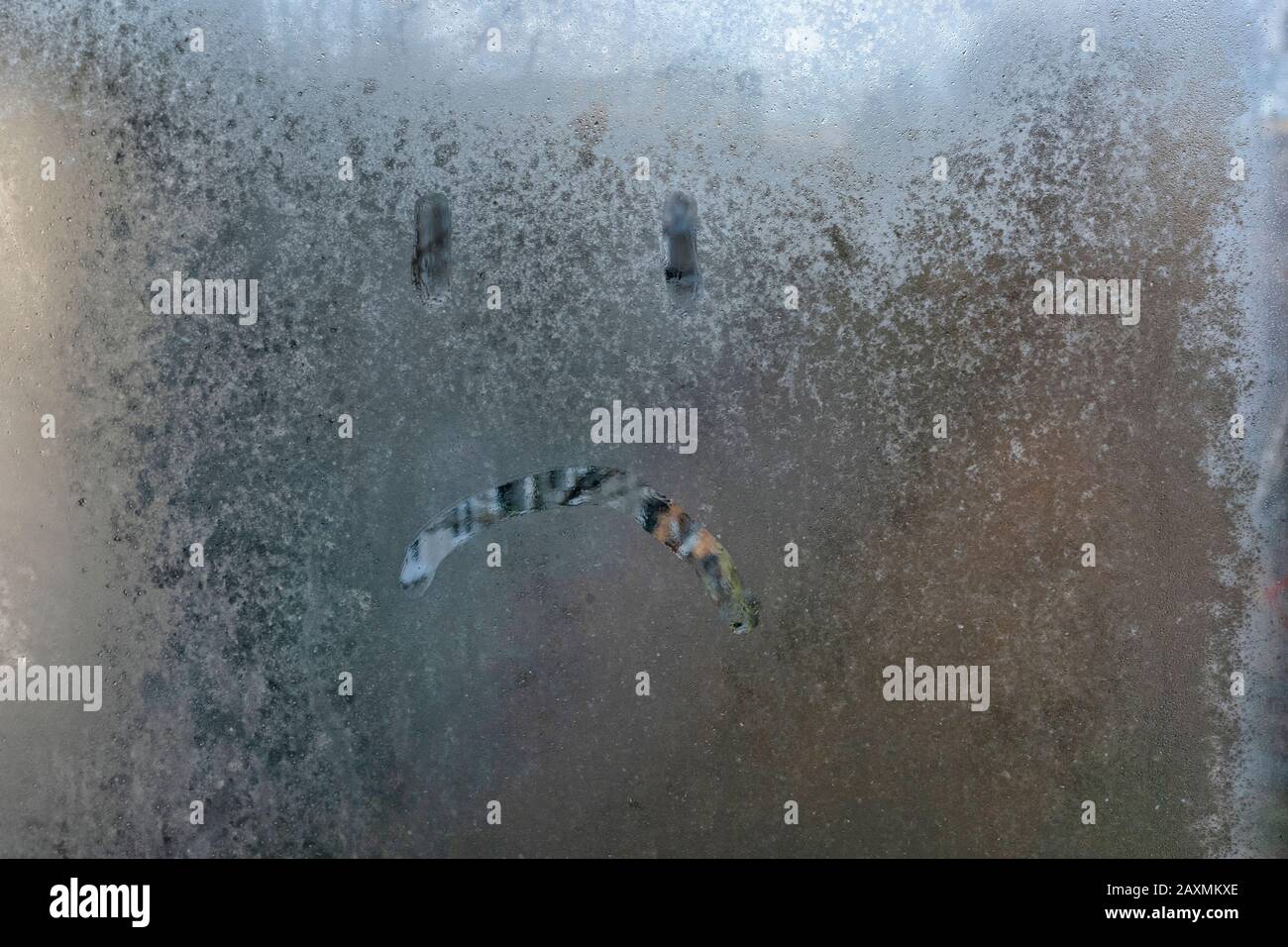 handwritten inscription on the glass sad face Stock Photo - Alamy