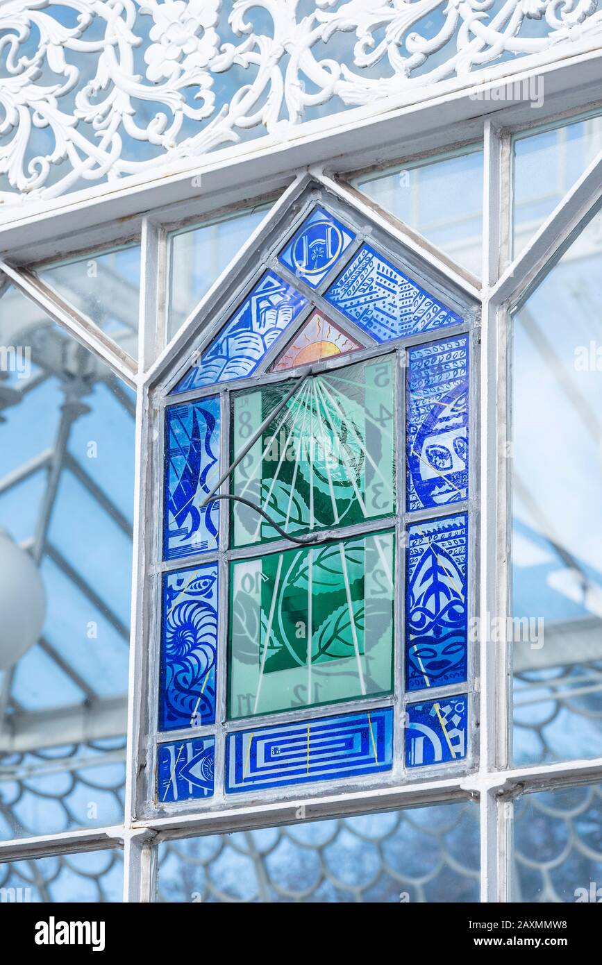 A stained glass sundial built into a museum's conservatory. The shadow ...