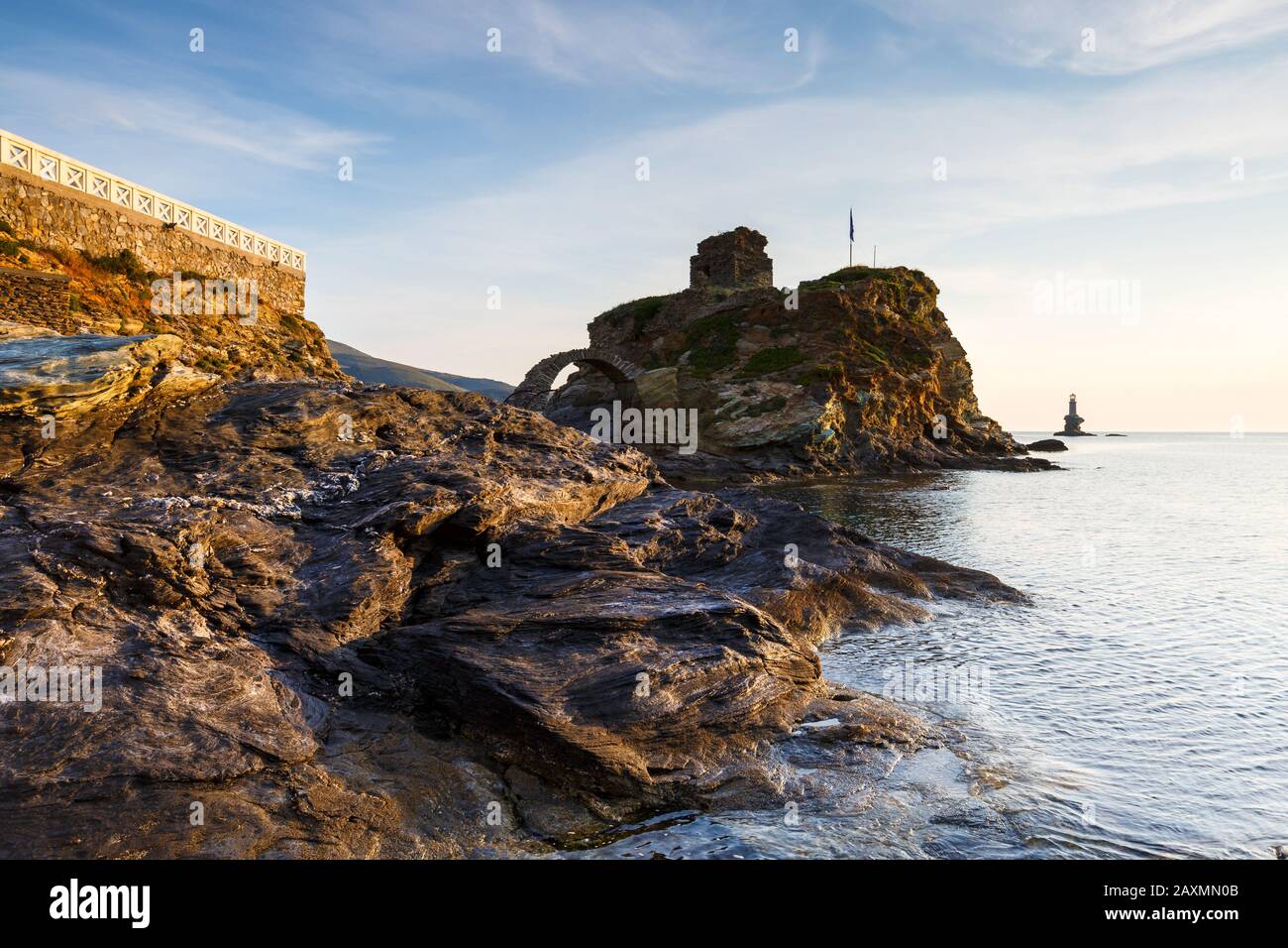 Castle and lighthouse in Chora of Andros island early in the morning ...