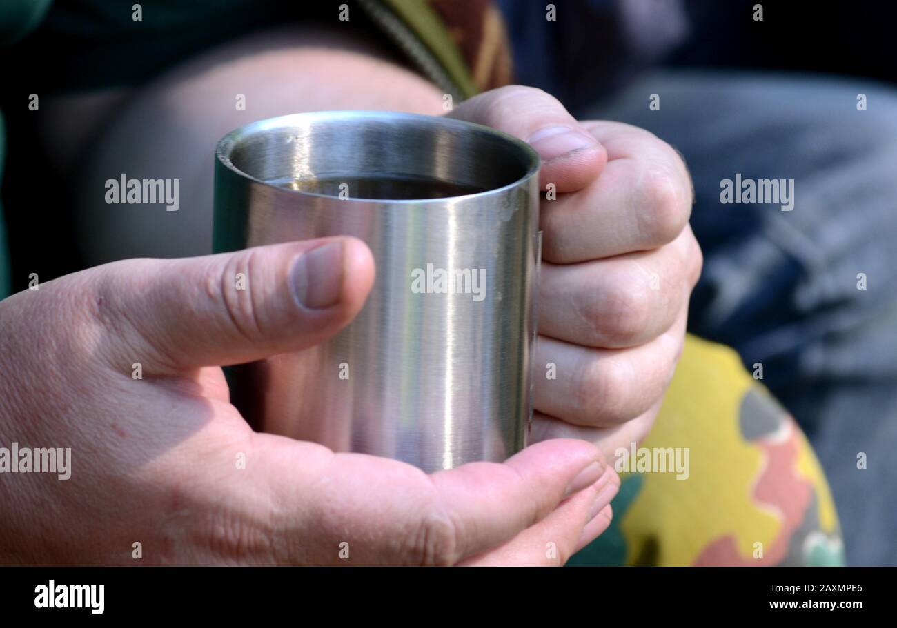 Man holding up a cup hi-res stock photography and images - Alamy