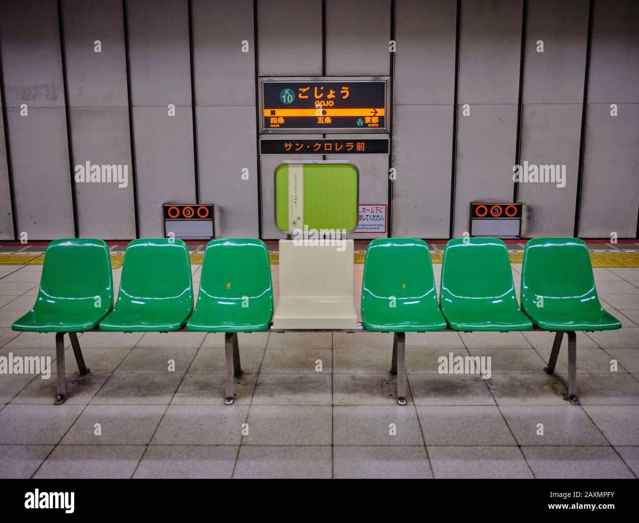 Six green chairs in a row at a train station in Japan Stock Photo - Alamy