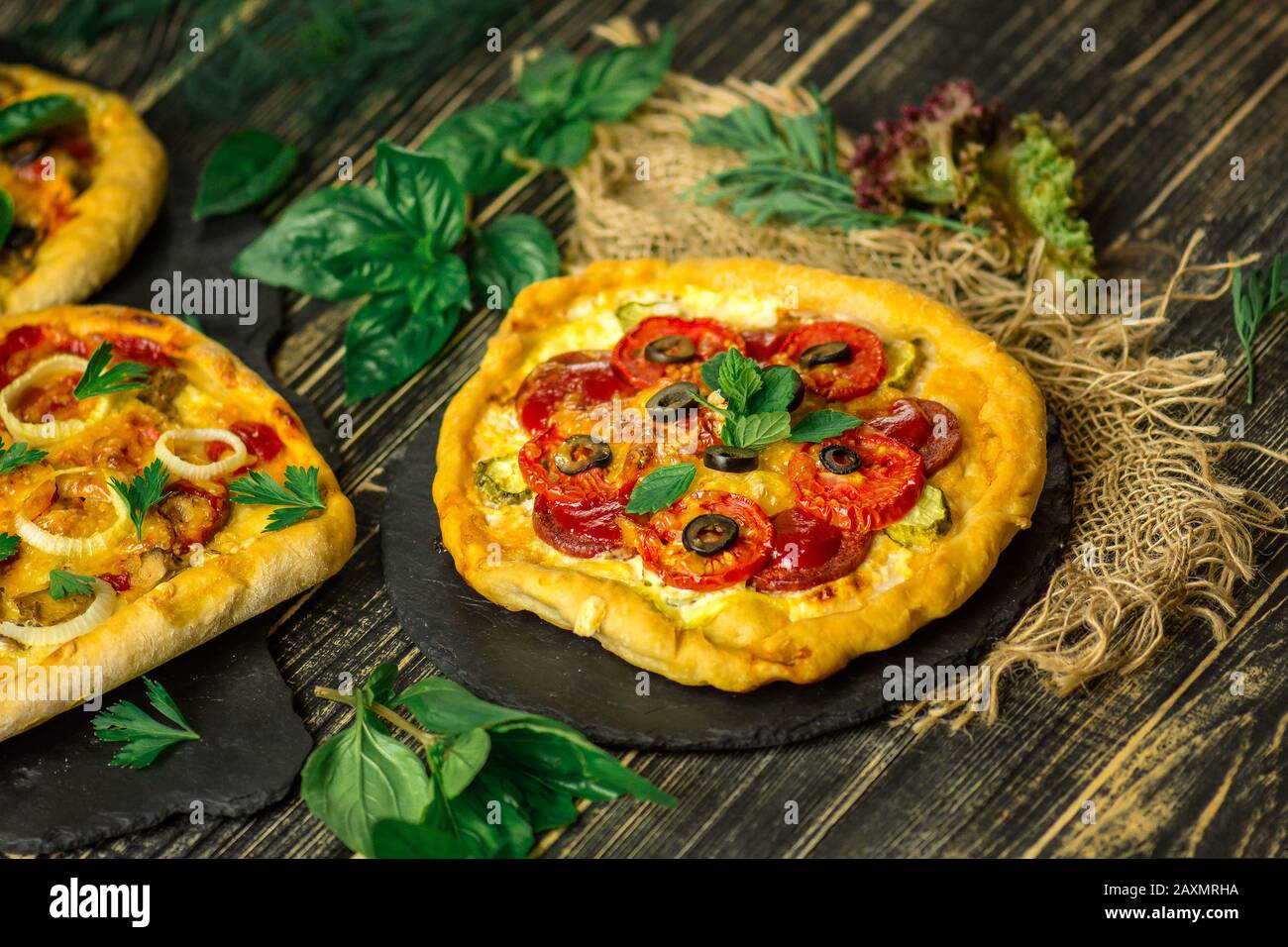 American pizza with mozzarella, tomato, pepperoni on dark wooden table ...