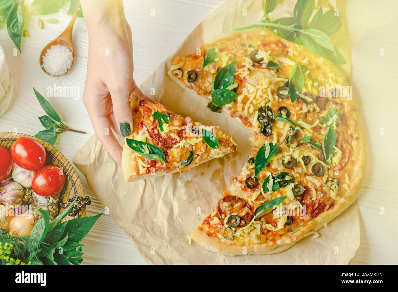 Hand taking pizza slices from white wooden background. Pizza and hand ...