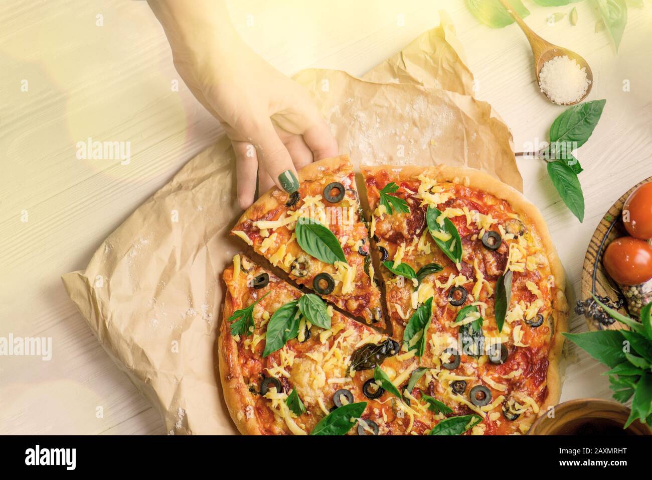 Hand taking pizza slices from white wooden background. Pizza and hand ...