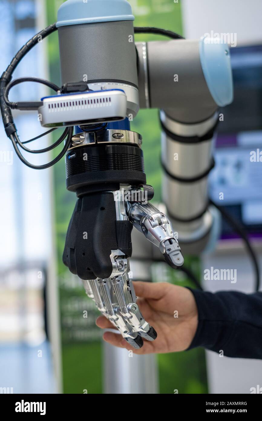 Human hand and robotic arm Stock Photo - Alamy