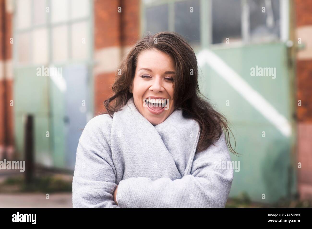 young woman outside standing and laughing Stock Photo - Alamy