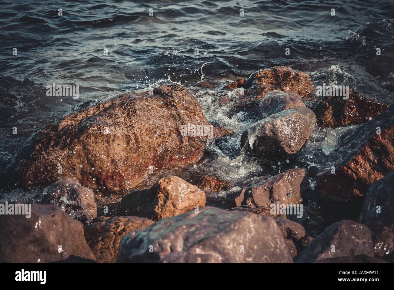 big wet rocks, splashing and shining sun, filter Stock Photo - Alamy