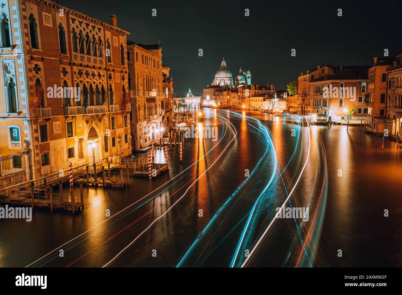 Venice twilight blue night scenery. Light illuminated trails of ferries ...