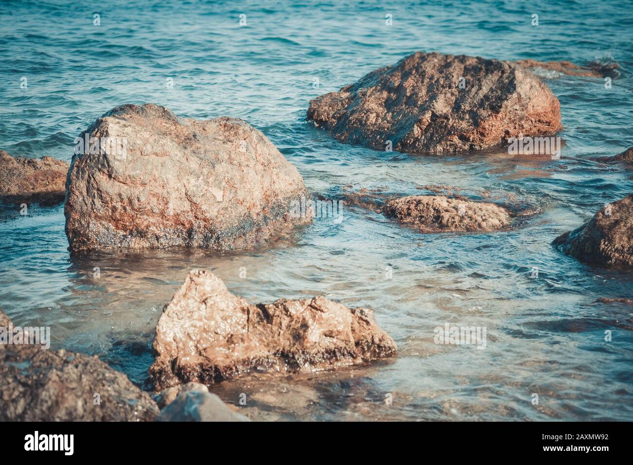 stones on the beach in the clear water, the filter Stock Photo - Alamy