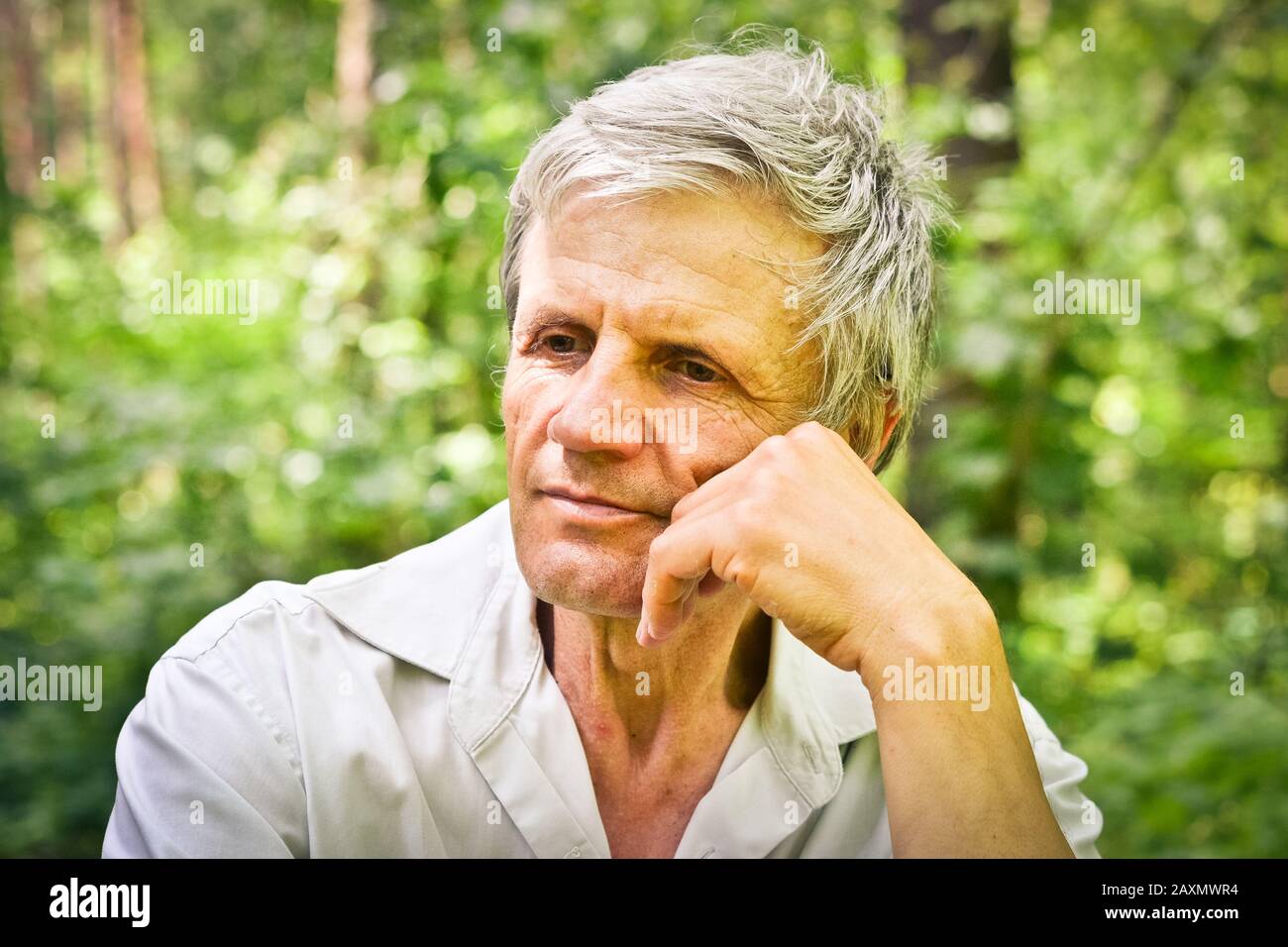 an old man thinking against the backdrop of greenery Stock Photo - Alamy