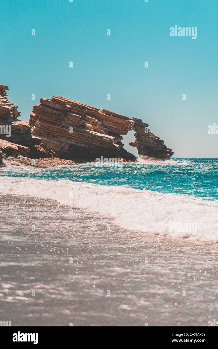 Three rocks in the ocean, Triopetra beach, Crete, Greece Stock Photo ...