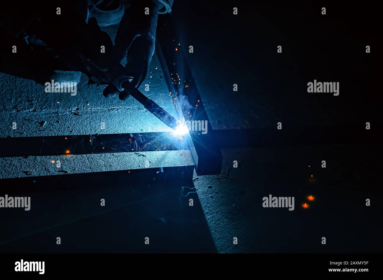 Welding a metal frame in a workshop with argon welding Stock Photo - Alamy