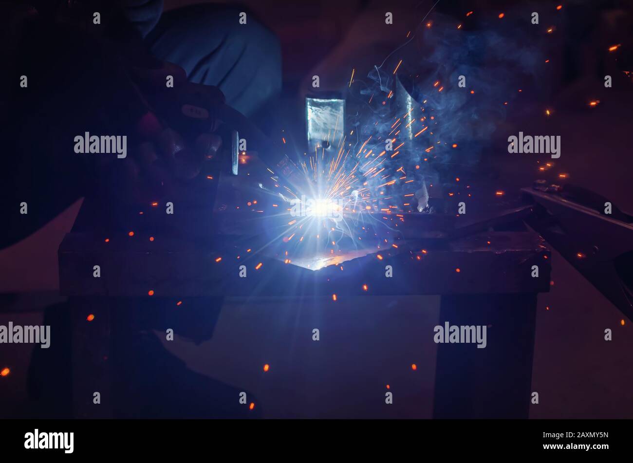 Metal welding in a metal workshop. Clear light, blue tinting Stock ...