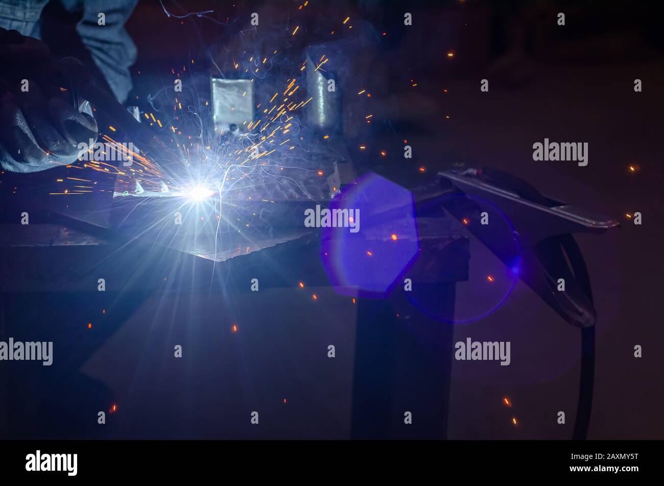 Metal welding in a metal workshop. Clear light, blue tinting Stock ...