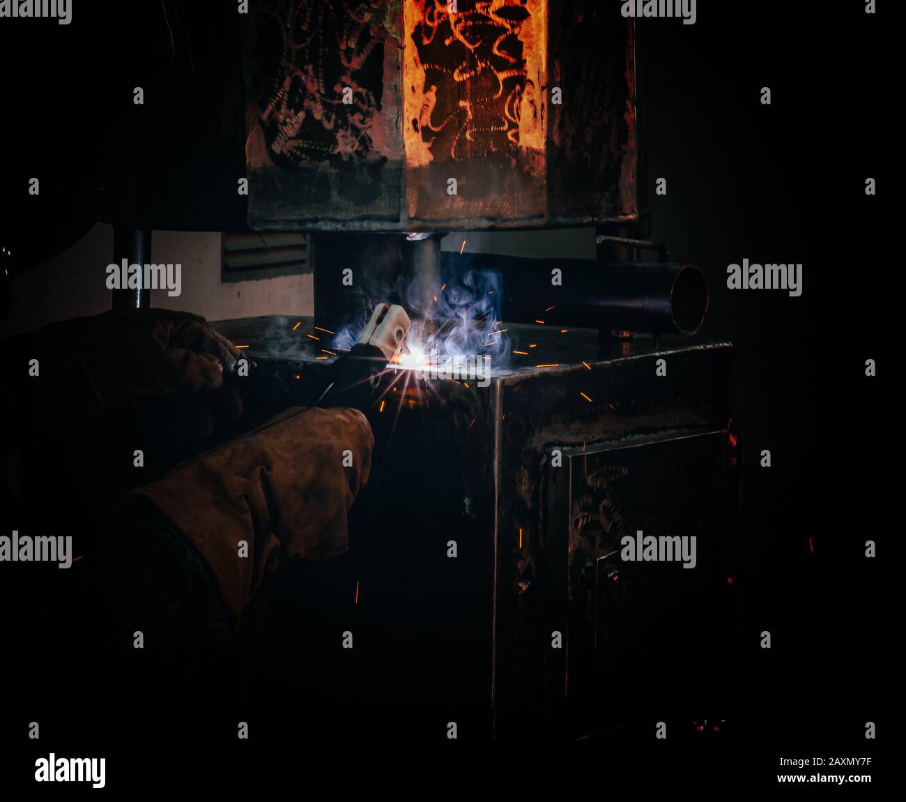 Spot welding of a metal product in a locksmith workshop Stock Photo - Alamy