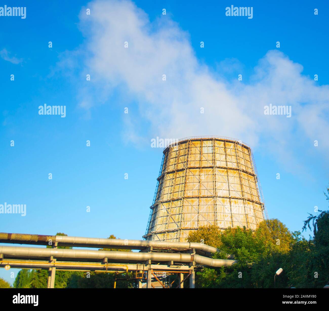 large pipe plant with smoke on a sunny day with clear blue sky in ...