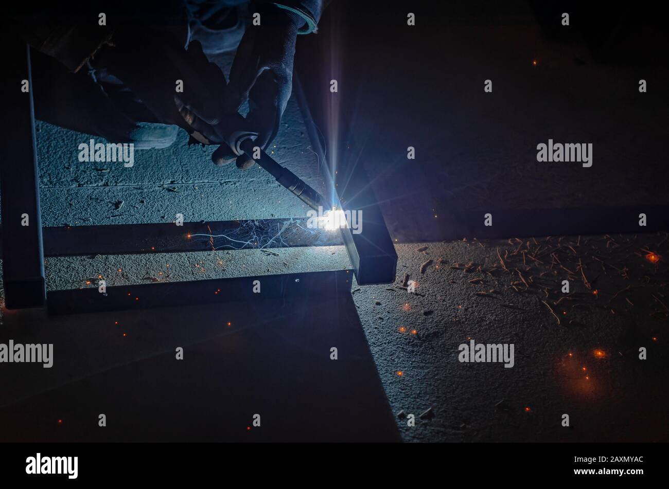 Welding a metal frame in a workshop with argon welding Stock Photo - Alamy