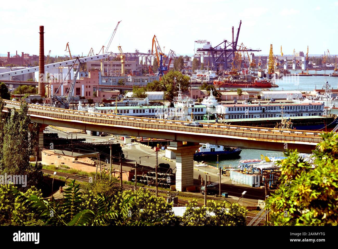 Seaport with large concrete road on the pillars and various ships and ...