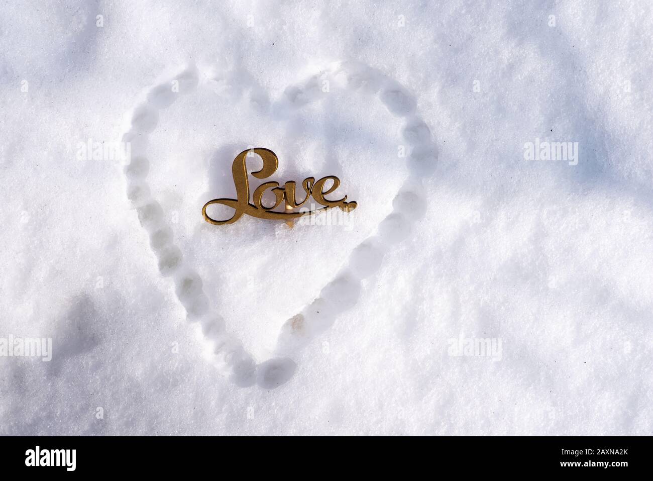 Love written in the snow with heart symbol Valentine's Day Concept ...