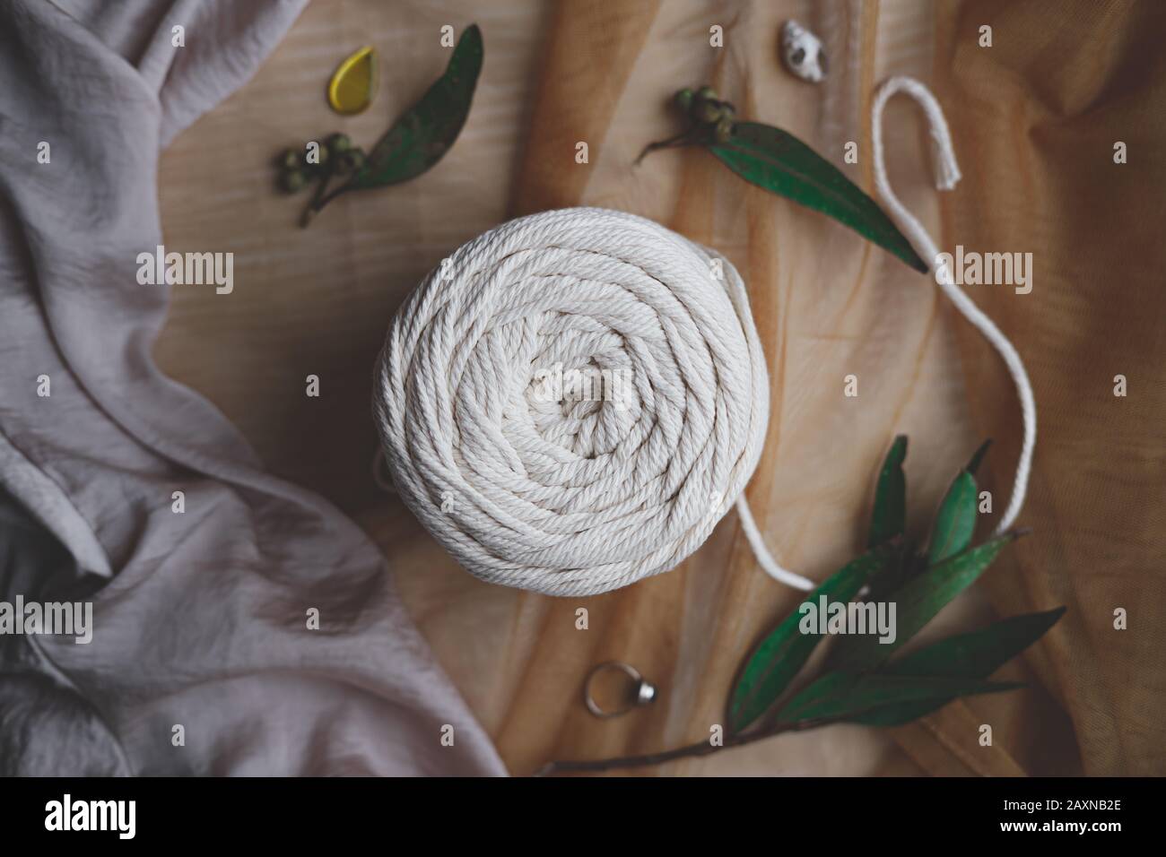 Roll of macrame rope, top view. White thread in beautiful pastel ...
