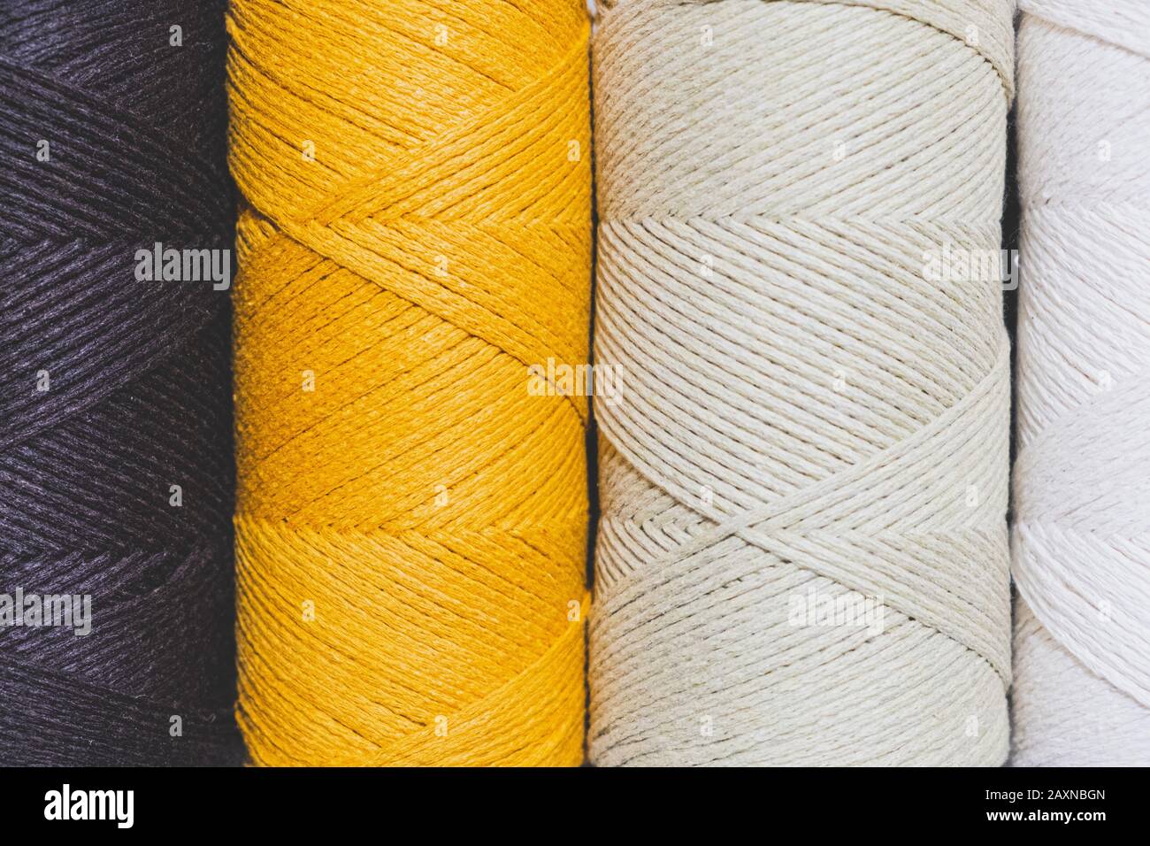 Macrame threads, close-up texture view. Rolls of crochet ropes in black ...