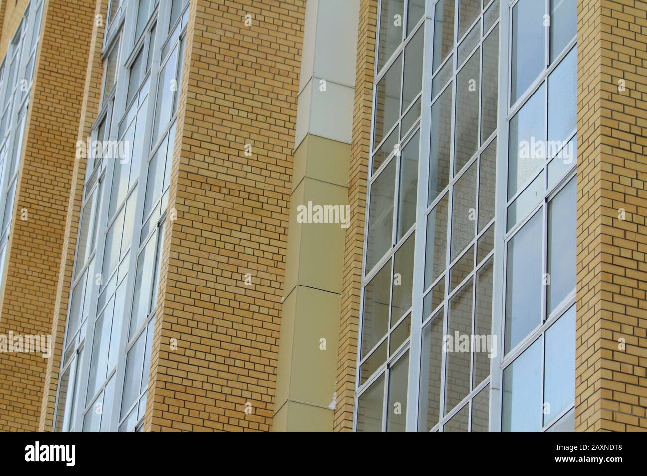 Plastic windows in a modern tiled brick high-rise house. Bottom view ...