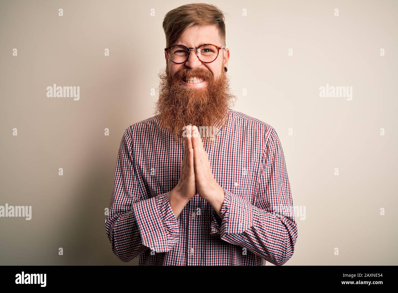 Handsome Irish redhead business man with beard wearing glasses over ...