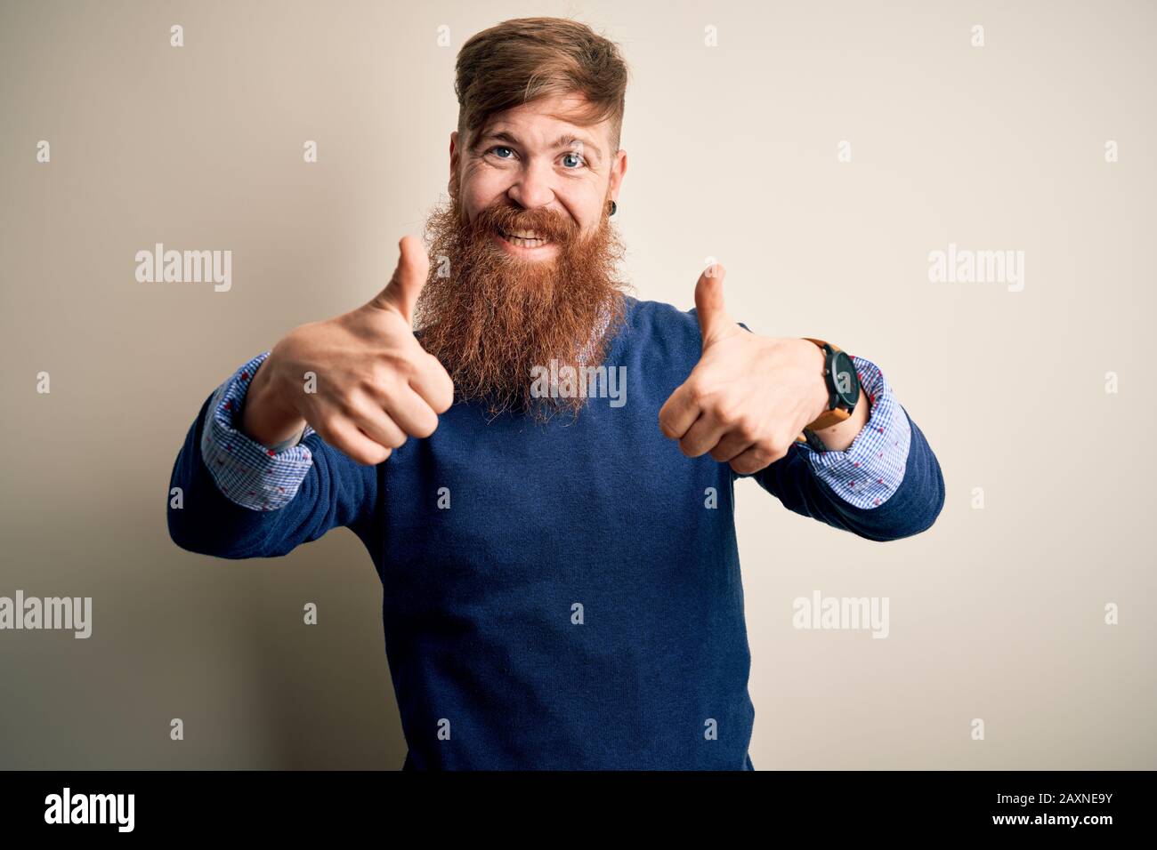 Handsome Irish redhead business man with beard standing over isolated ...