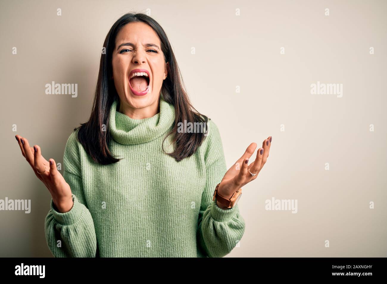 Young brunette woman with blue eyes wearing turtleneck sweater over ...