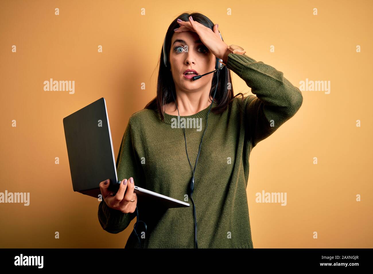 Young operator woman with blue eyes working on call center using ...