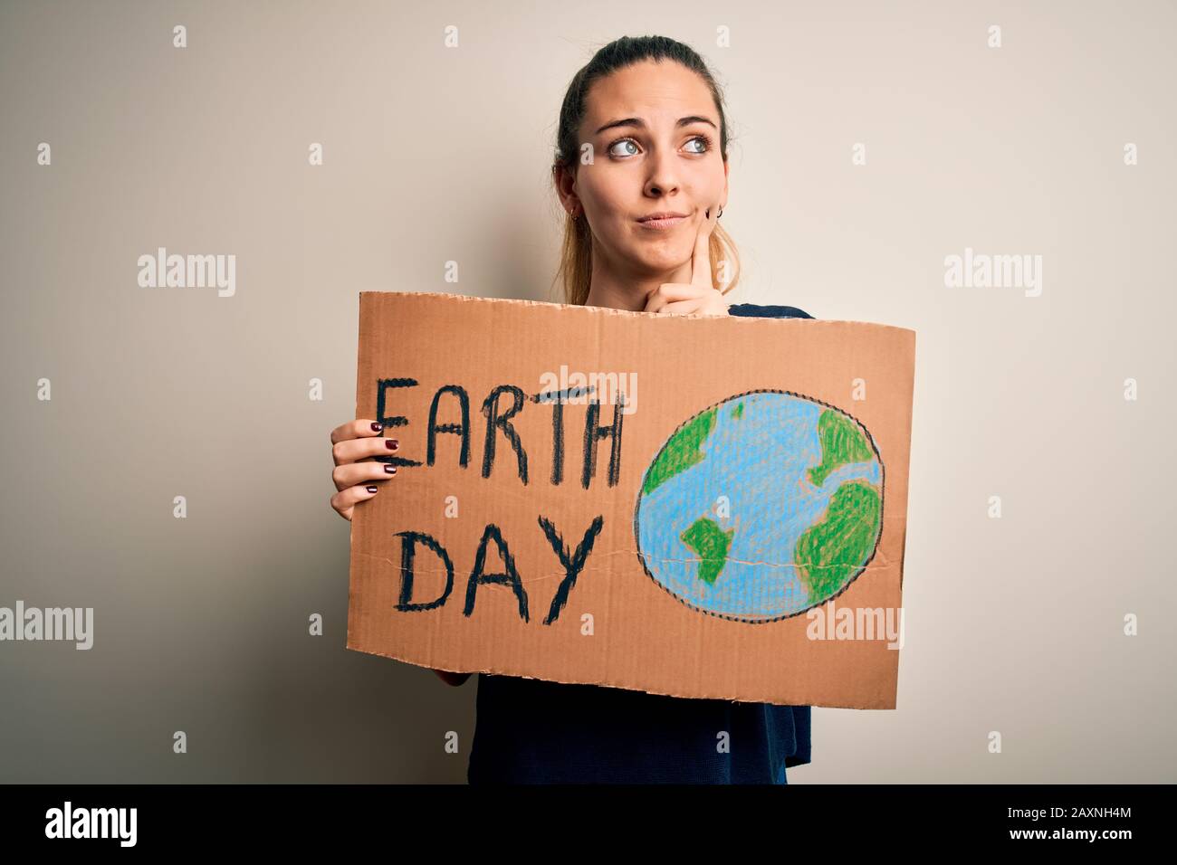 Young beautiful woman holding banner asking for earth and enviroment ...
