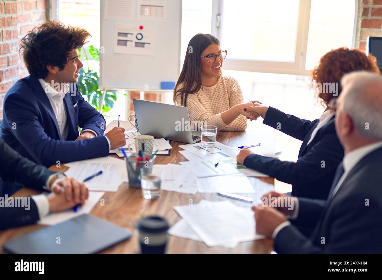 Group of business workers smiling happy and confident in a meeting ...
