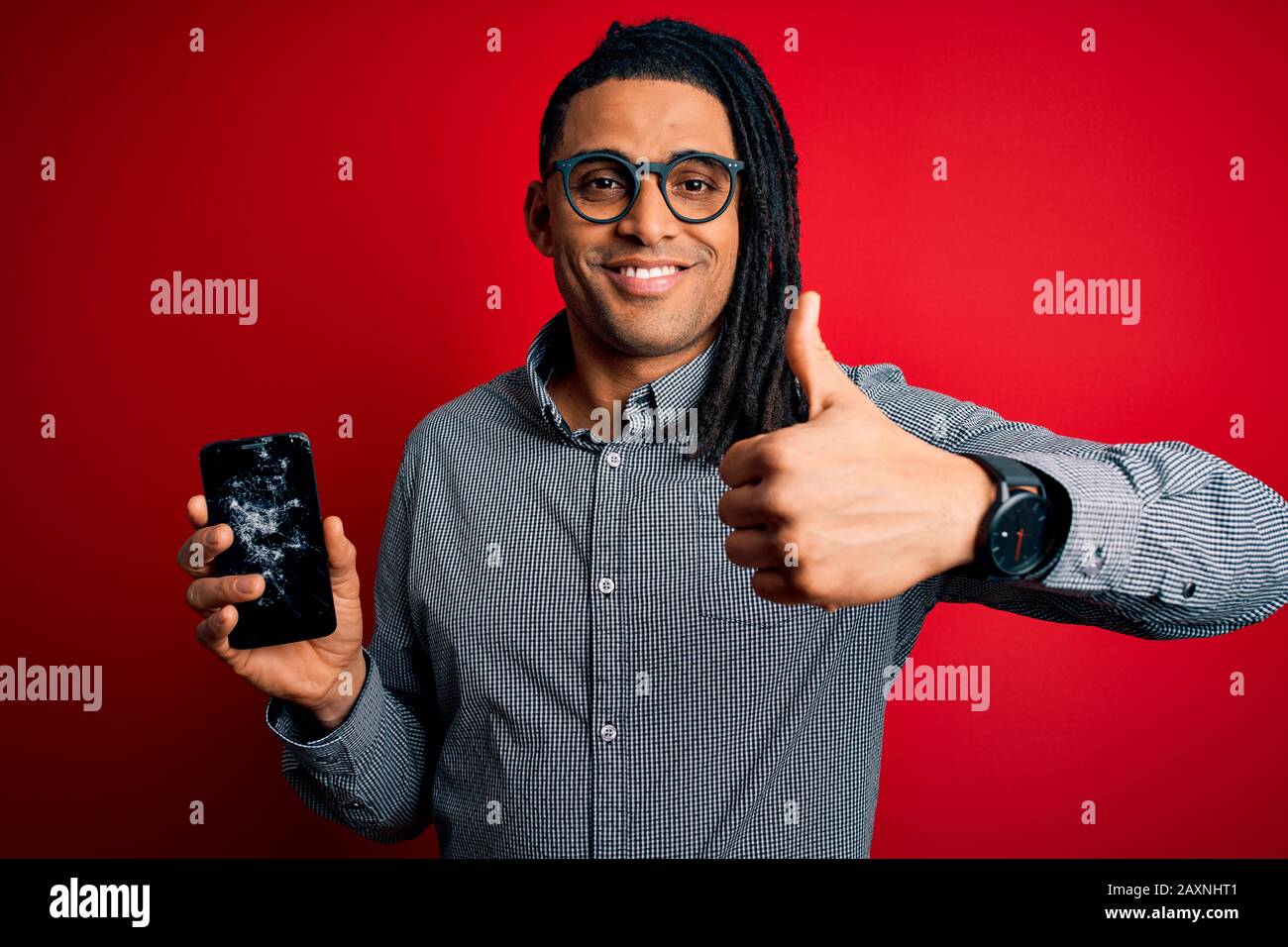 Young african american afro man holding broken smartphone showing ...
