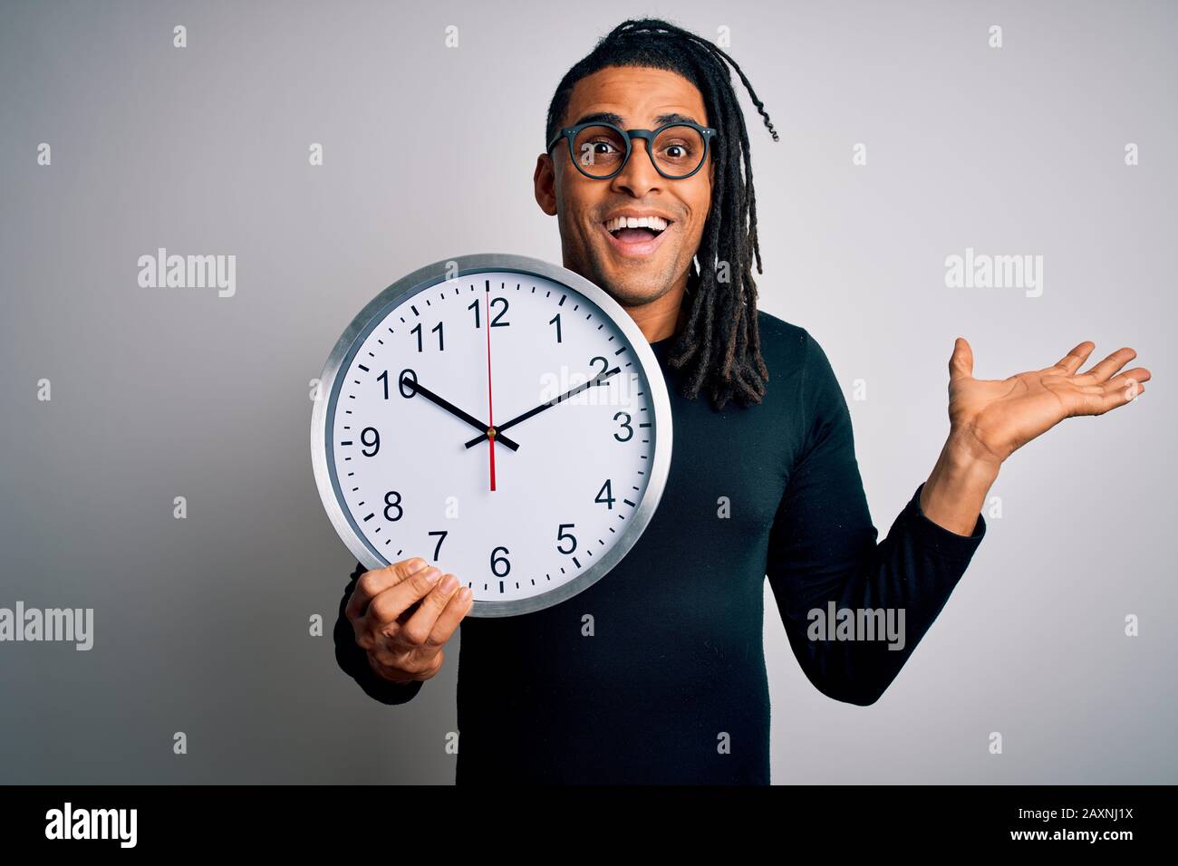 Young african american afro man doing countdown holding bic clock over ...